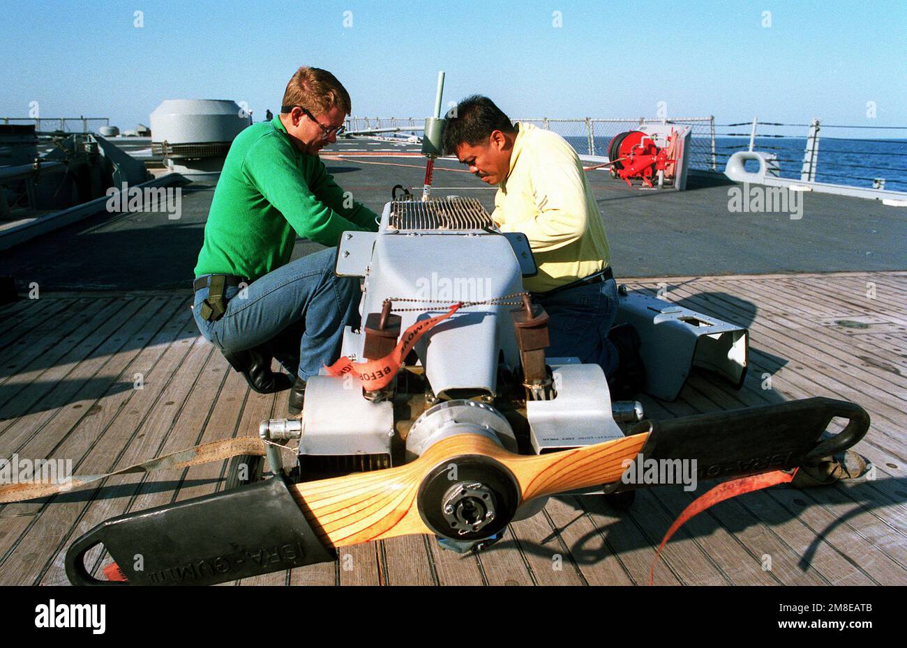 Crew members aboard the battleship USS WISCONSIN (BB-64) prepare a ...