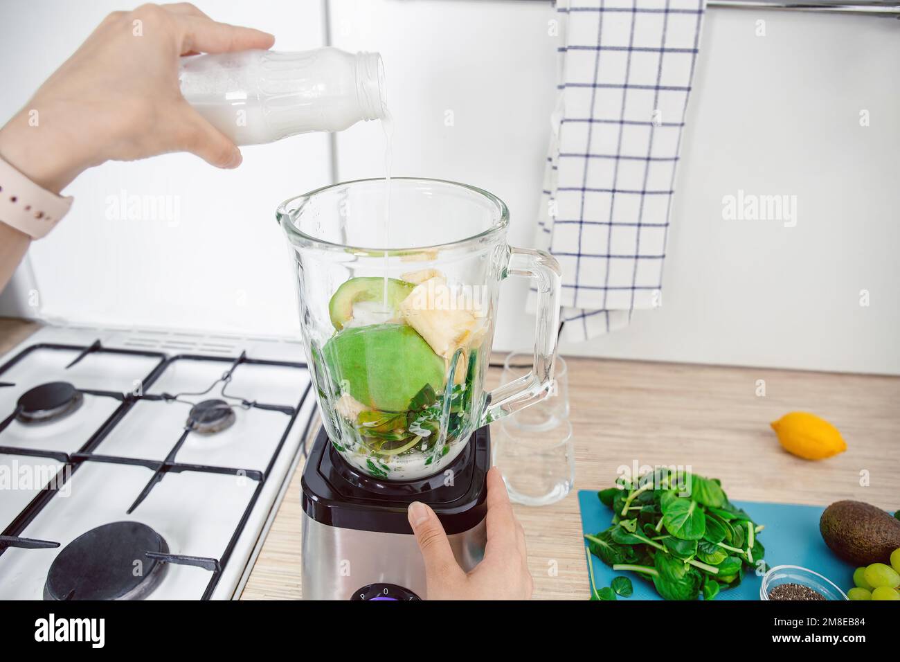 Making a healthy green smoothie from fruits and vegetables. Diet ...