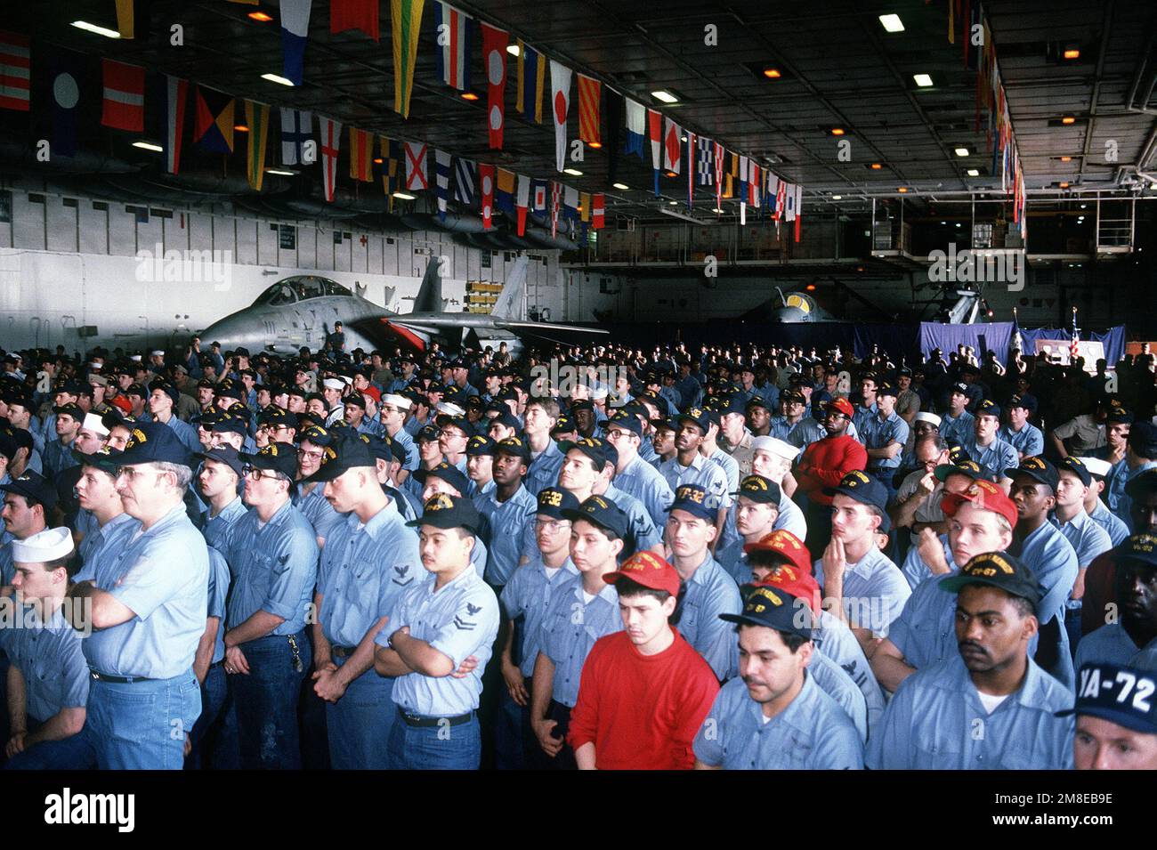 Crew members of the aircraft carrier USS JOHN F. KENNEDY (CV-67) listen ...