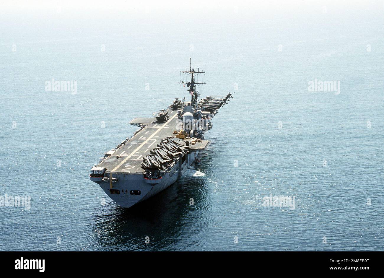 Various helicopters line the deck of the amphibious assault ship USS ...