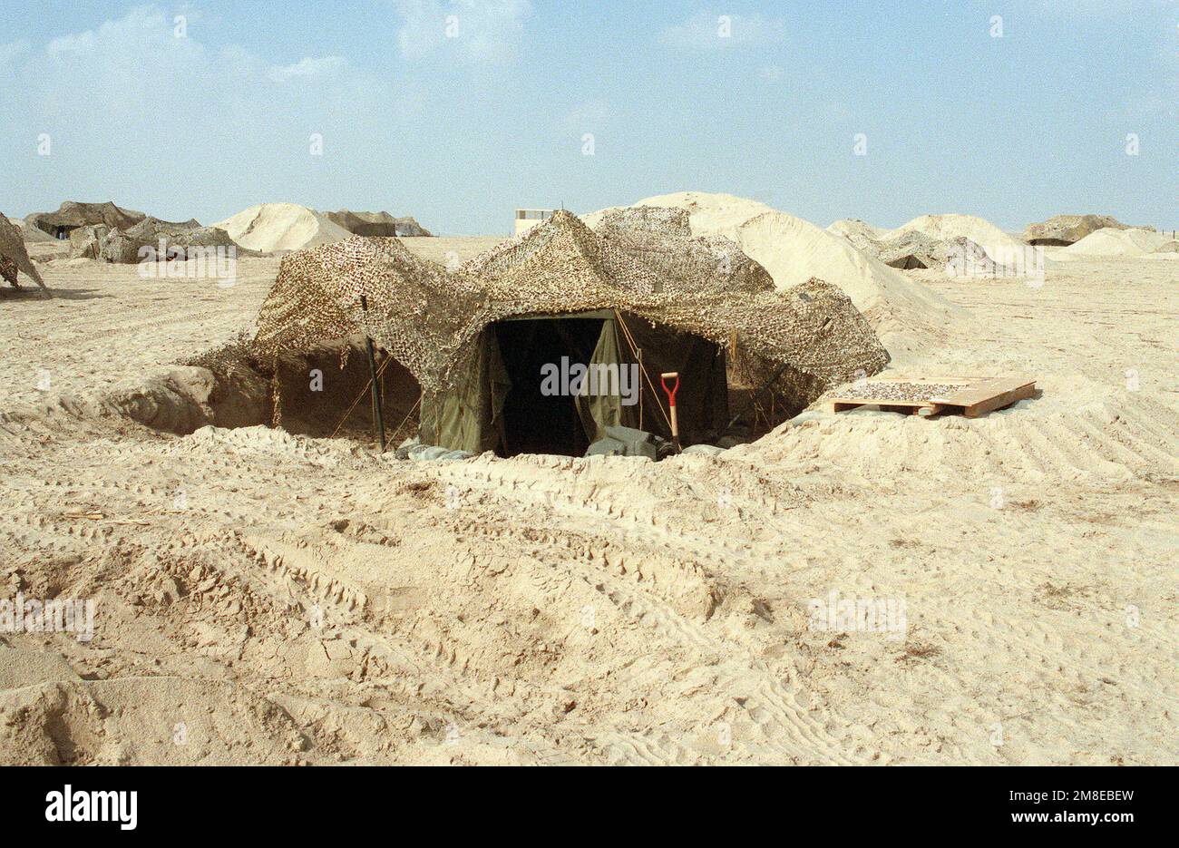 A view of a tent covered with camouflage netting erected at the 3rd ...