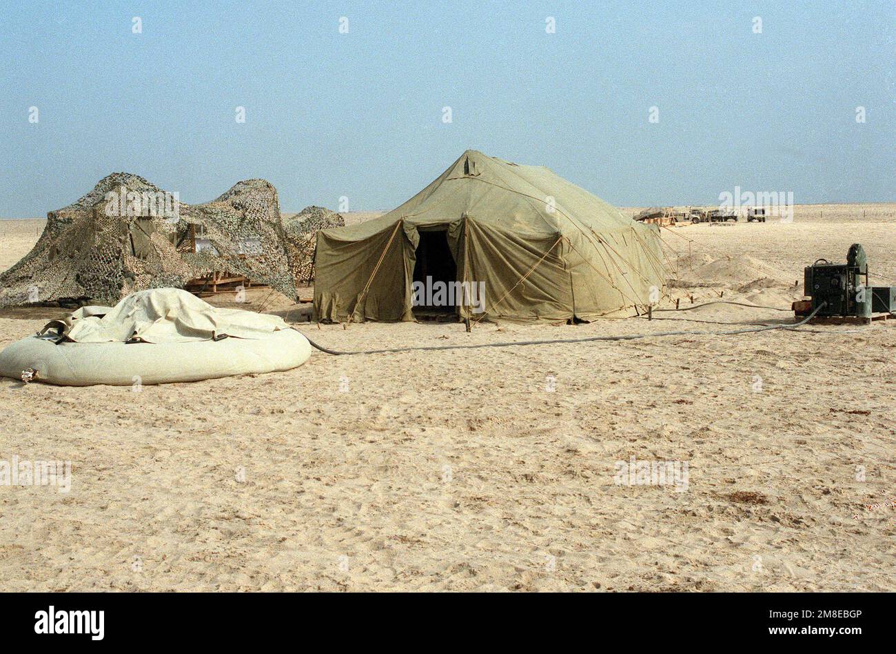 A view of tents and a collapsible water bladder in the 3rd Marine ...