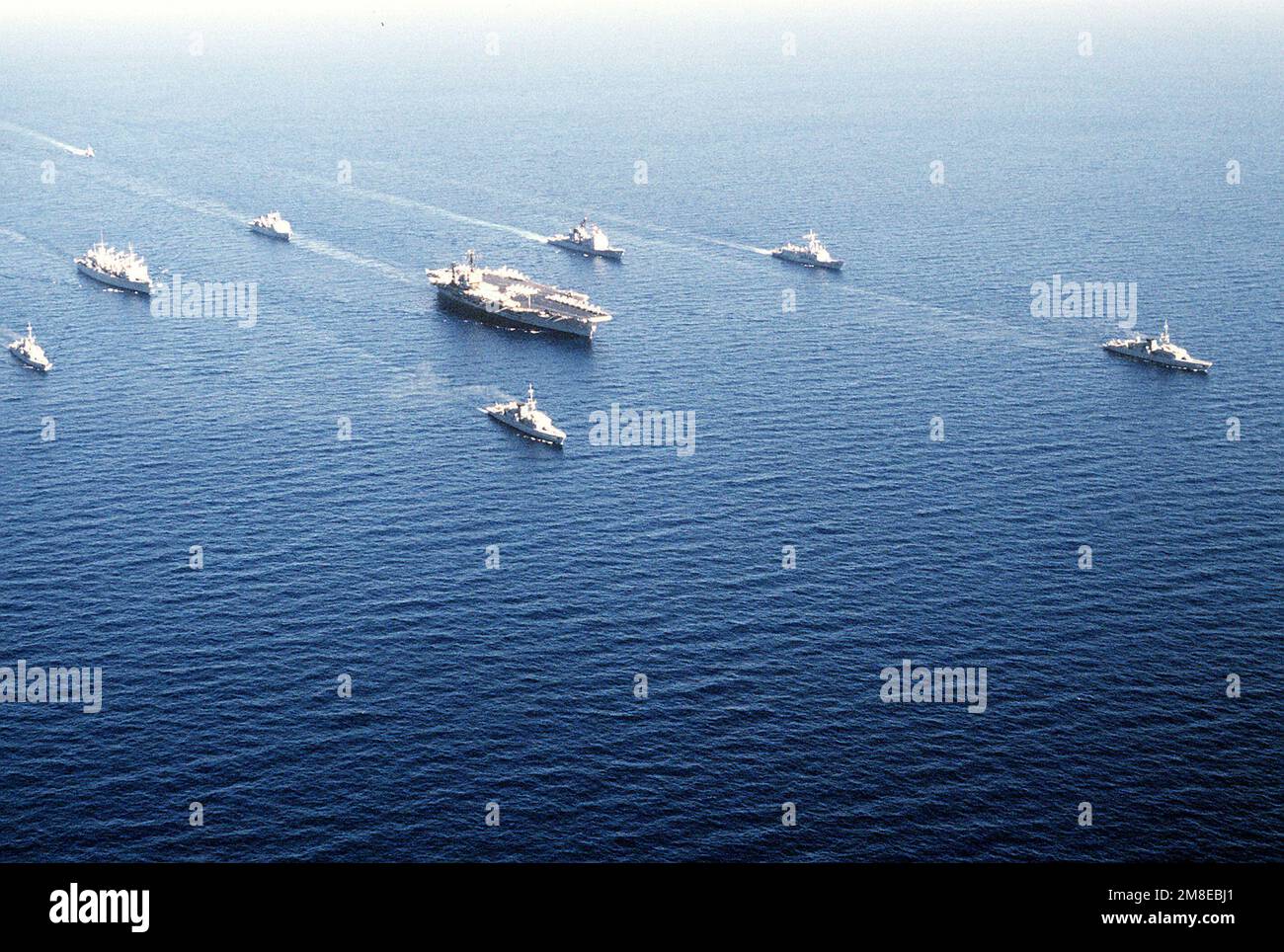 An aerial starboard bow view of nine ships of Battle Force Red Sea ...
