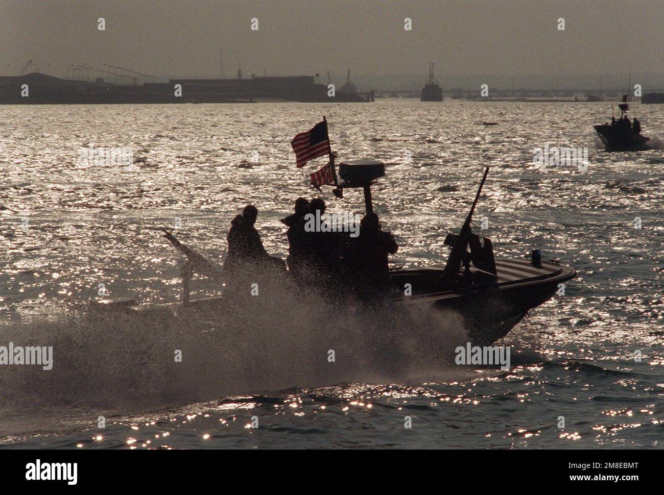 Coast Guard security personnel in a Sea Raider utility craft are ...