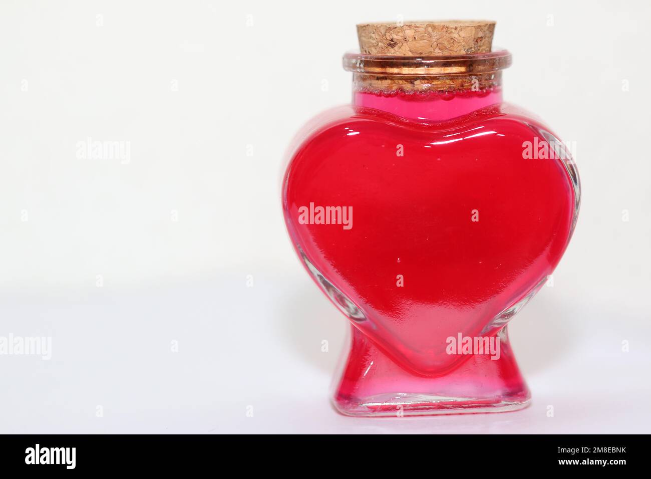 Heart shaped glass container on a white background Stock Photo - Alamy
