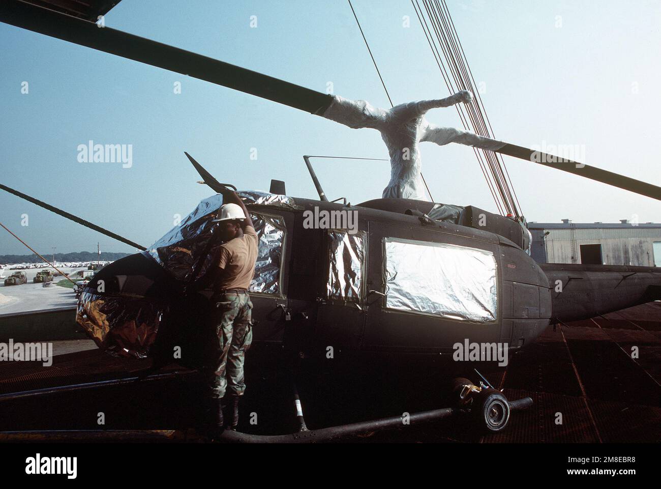 A member of the 101st Combat Support Group stands on the tow bar as a ...