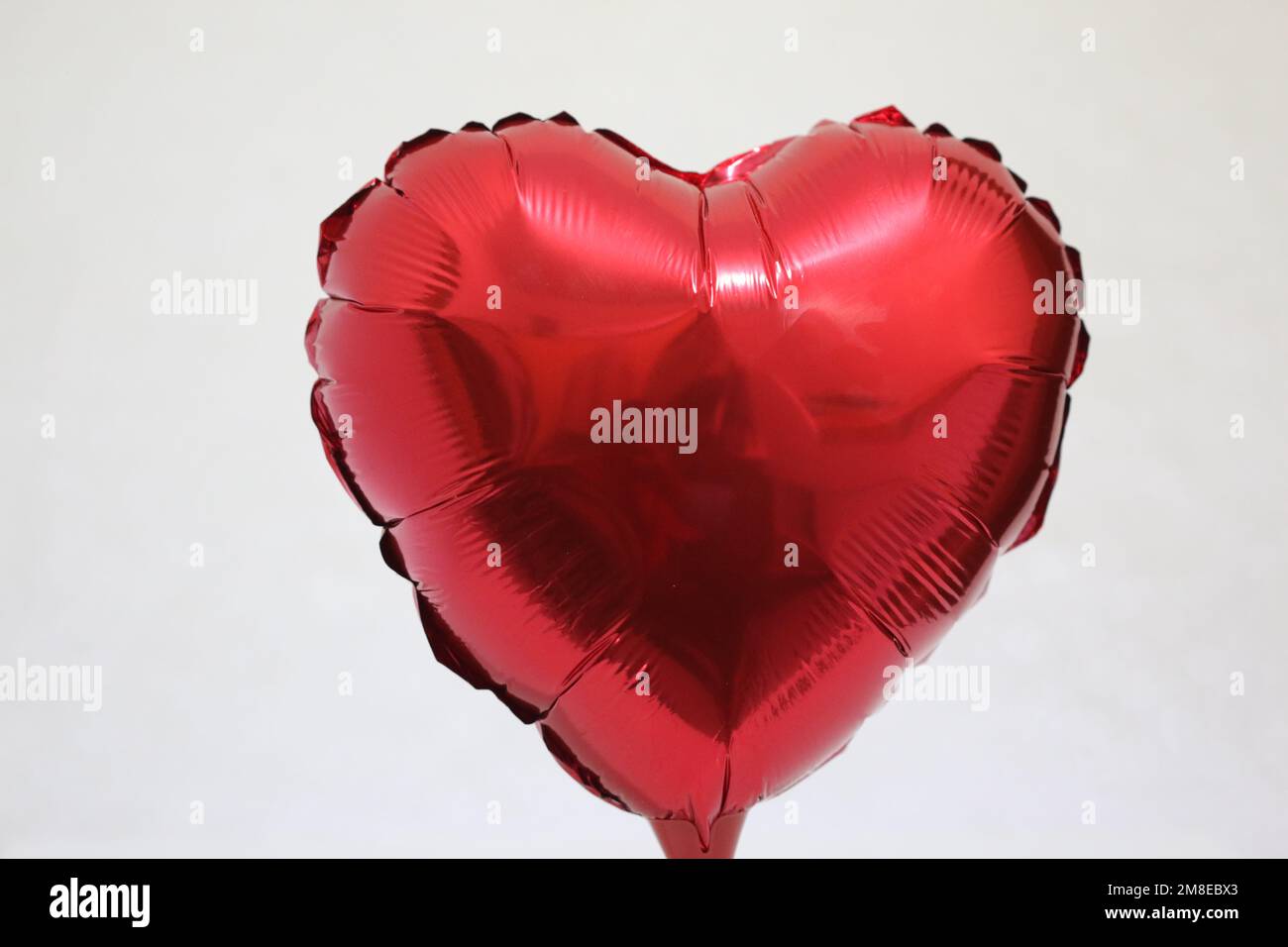 Heart shaped red inflatable balloon Stock Photo - Alamy