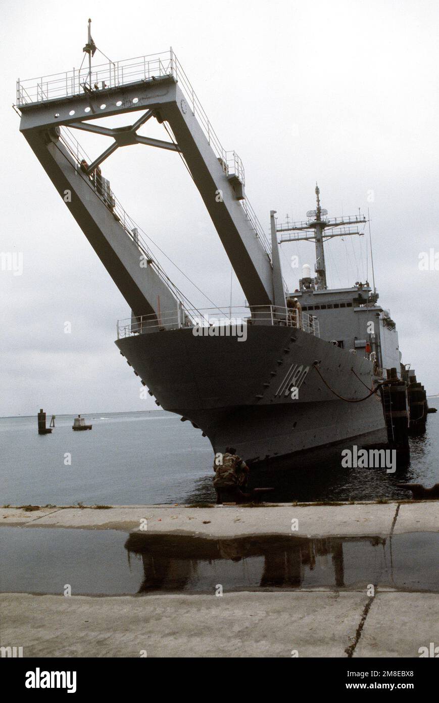 The tank landing ship USS MANITOWOC (LST-1180) lies tied up in front of ...