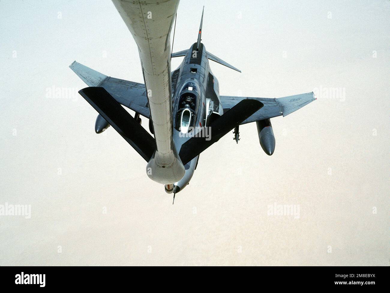 A 35th Tactical Fighter Wing F-4G Phantom II aircraft approaches the refueling boom of a KC-135 ...