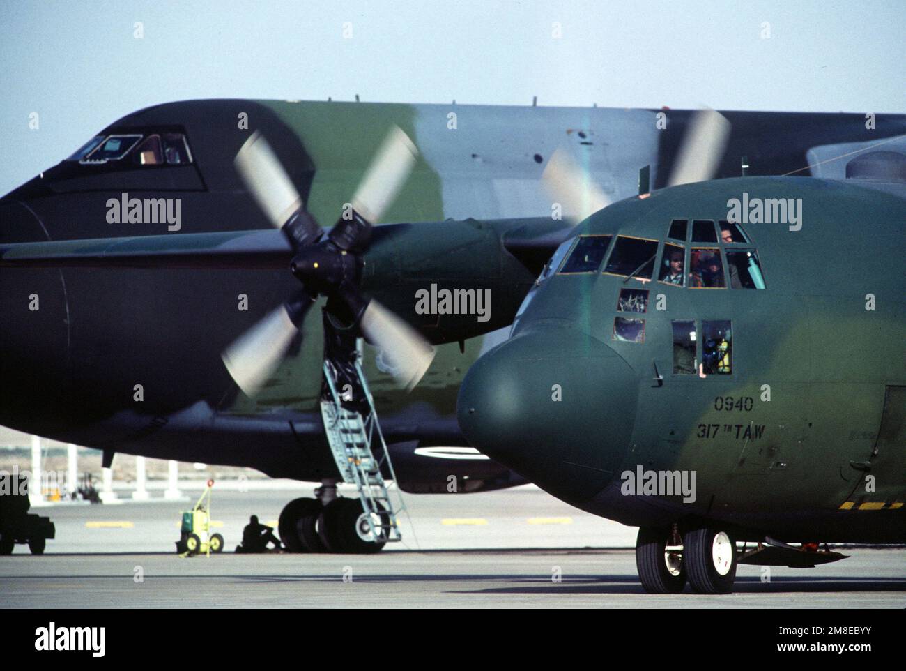 A 317th Tactical Airlift Wing C-130 Hercules aircraft, foreground ...