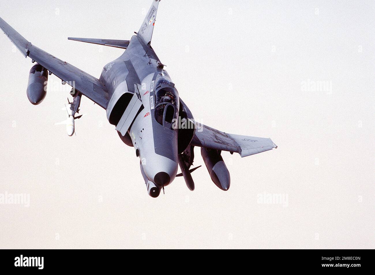 A 35th Tactical Fighter Wing F-4G Phantom II aircraft banks to the left while on a training ...