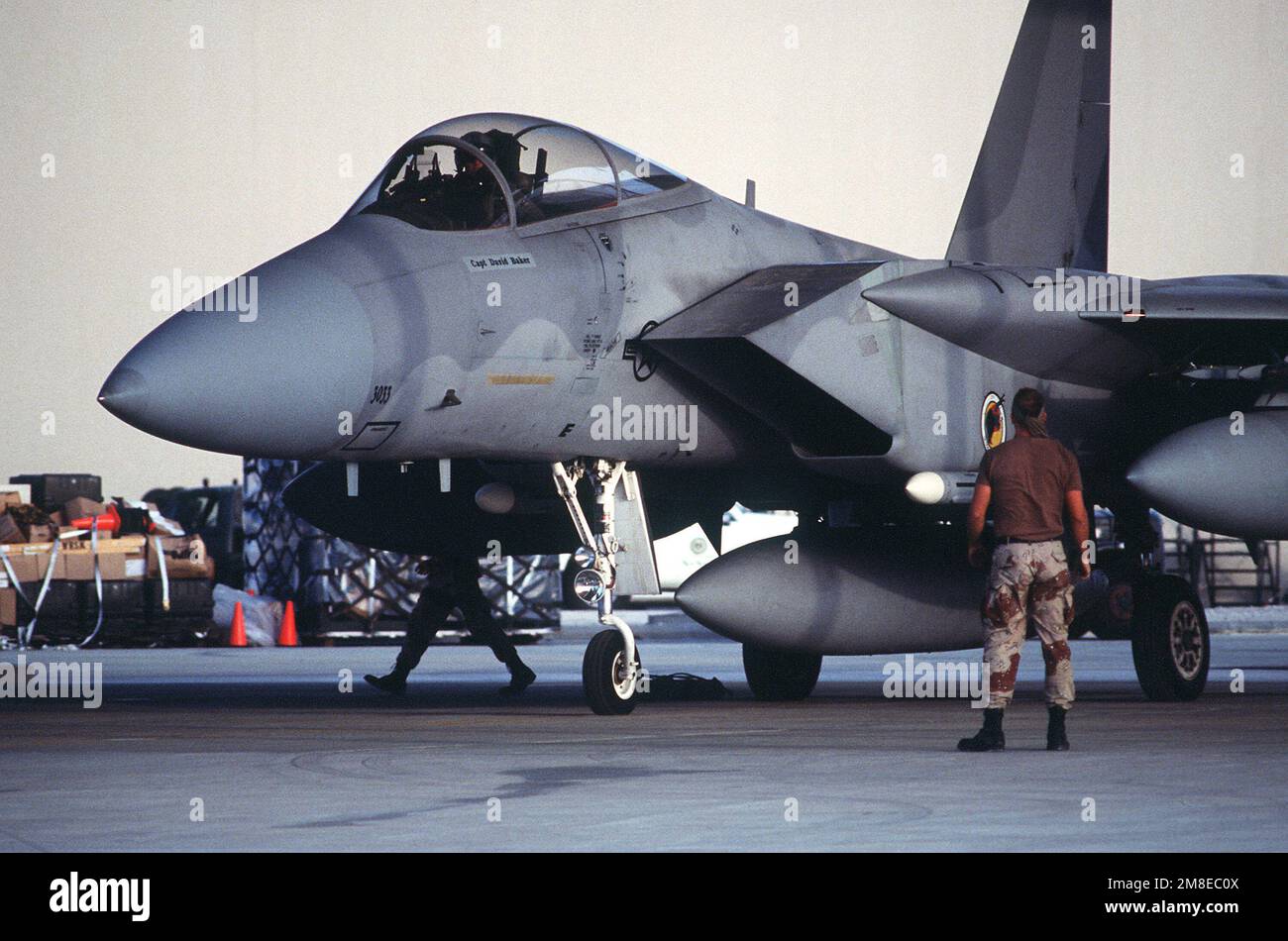 Ground guides walk alongside an F-15C Eagle aircraft of the 1ST ...