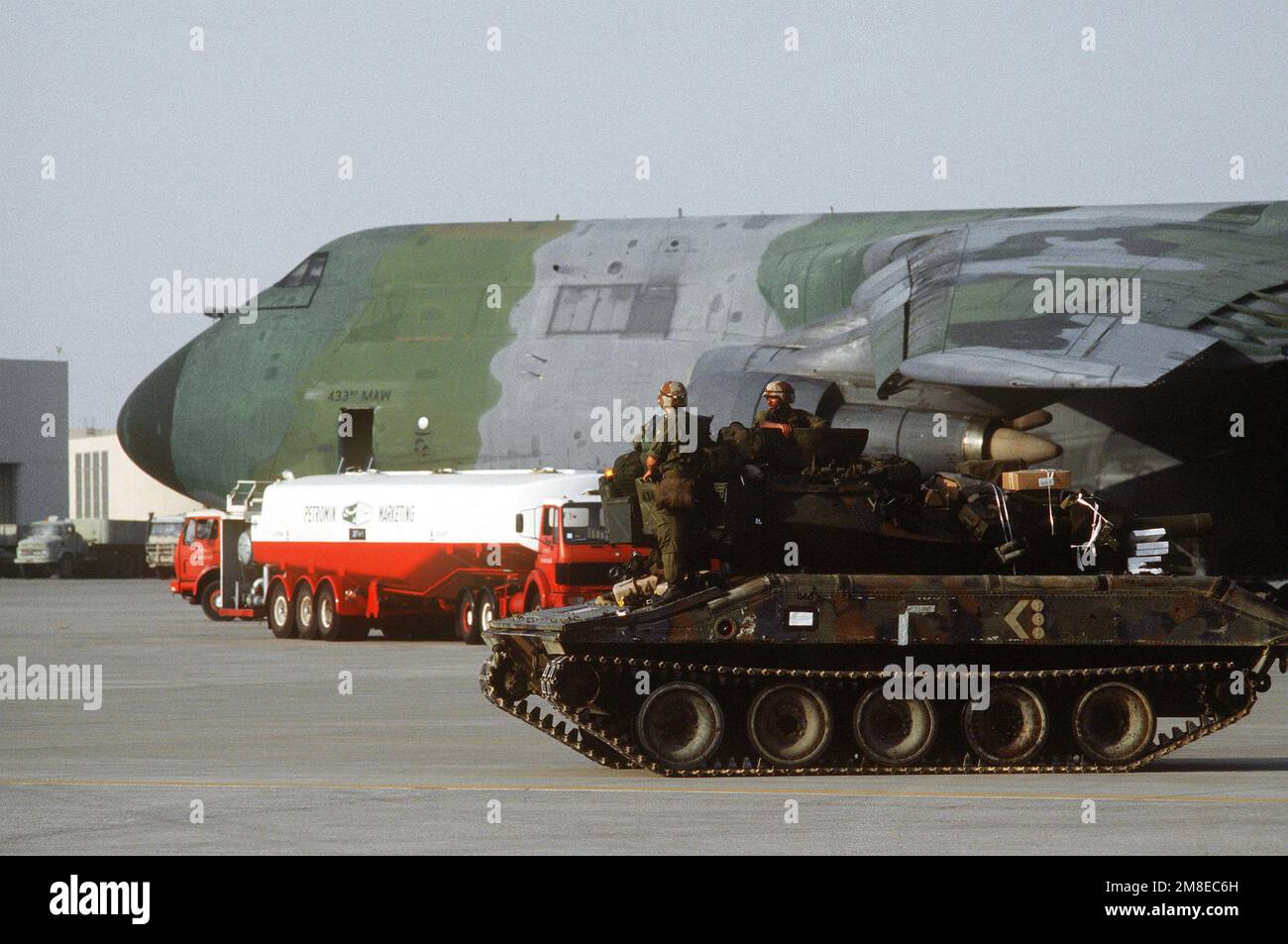 A soldier looks at a 433rd Military Airlift Wing C-5 Galaxy aircraft ...