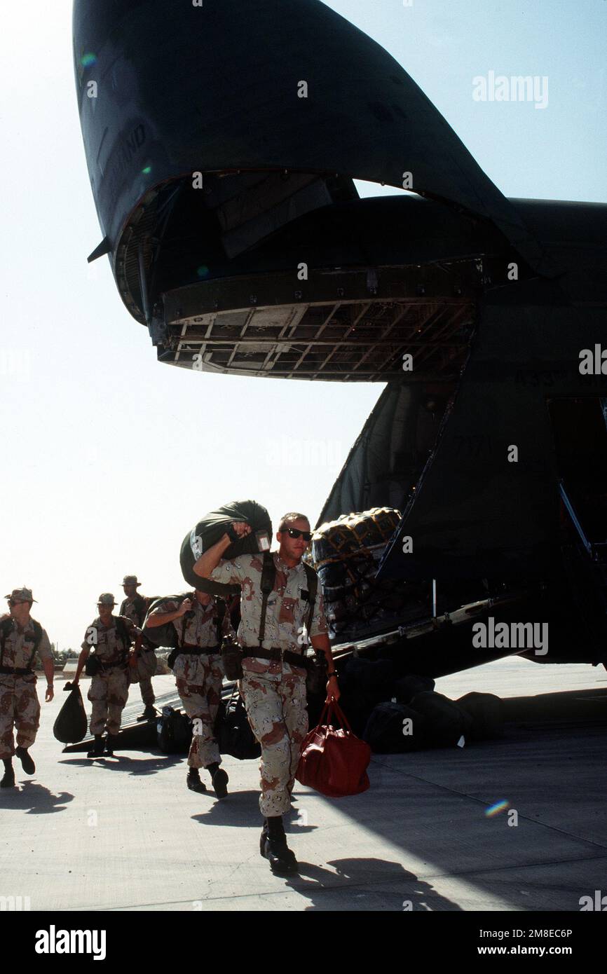 Military personnel disembark from a 433rd Military Airlift Wing C-5 ...