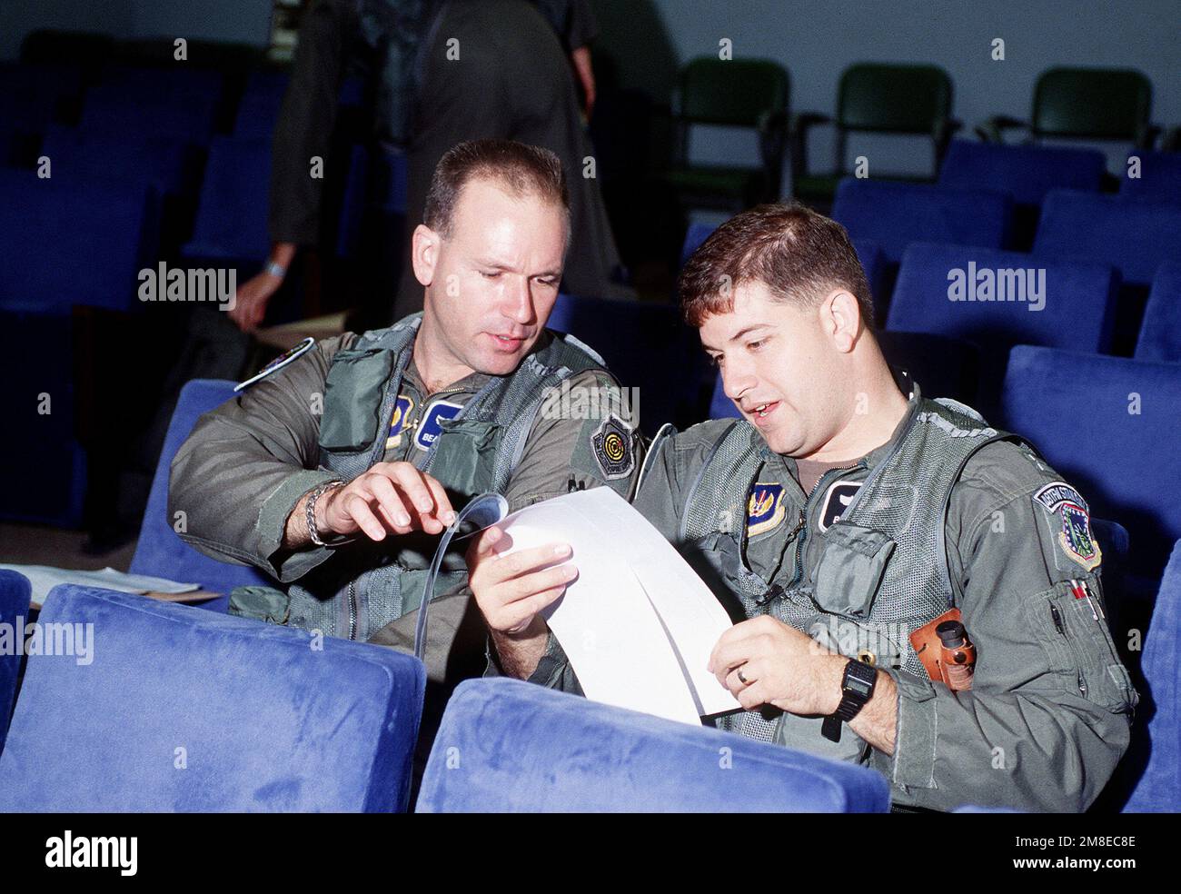 Two flight officers with the 48th Tactical Fighter Wing read over some ...