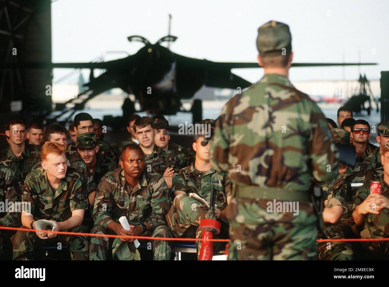 Members of the 48th Tactical Fighter Wing listen to a briefing as they ...