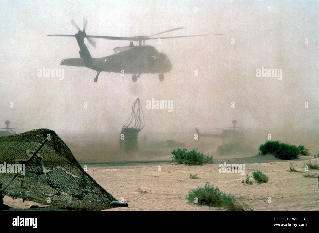 A UH-60 Black Hawk (Blackhawk) helicopter drops off an external load at ...