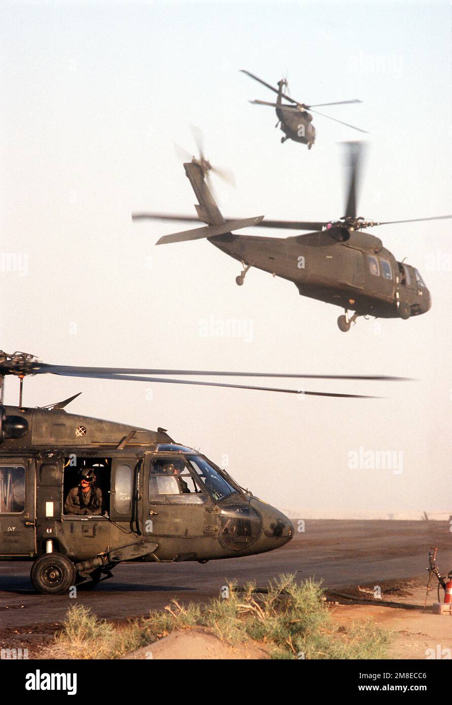 A UH-60 Black Hawk (Blackhawk) helicopter prepares to follow two other ...
