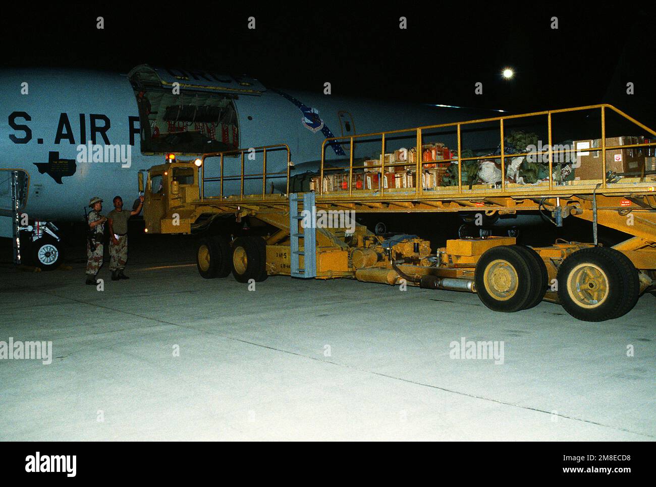 A K-Loader carrying ammunition and other gear pulls up beside a KC-135E ...