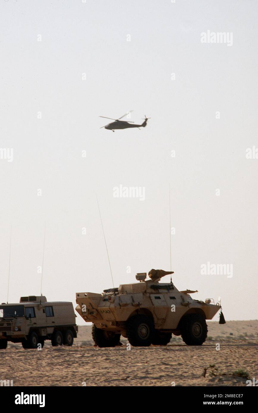 A UH-60 Black Hawk (Blackhawk) helicopter flies near two Saudi military ...