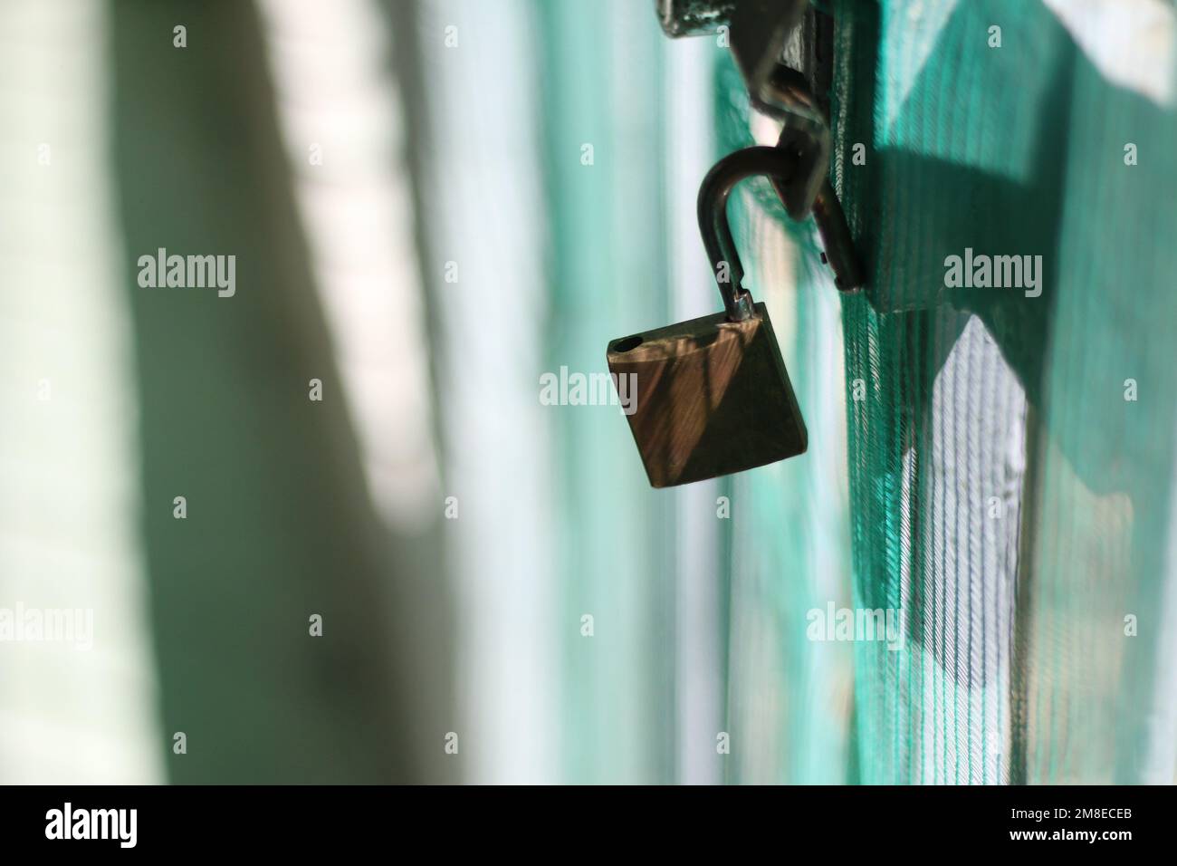 Open padlock hanging from the loop that is hanging from a railing Stock ...