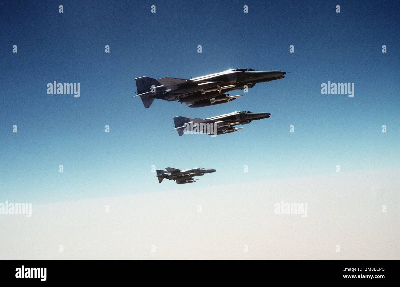Three 35th Tactical Fighter Wing F-4G Phantom II aircraft pass over the ...