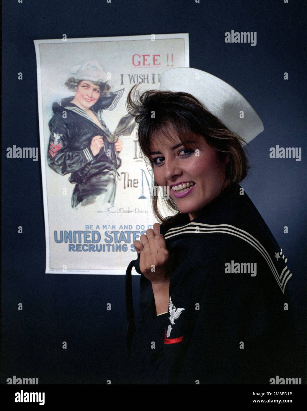 Personnelman 3rd Class Clara Gardner poses beside a Navy recruiting ...