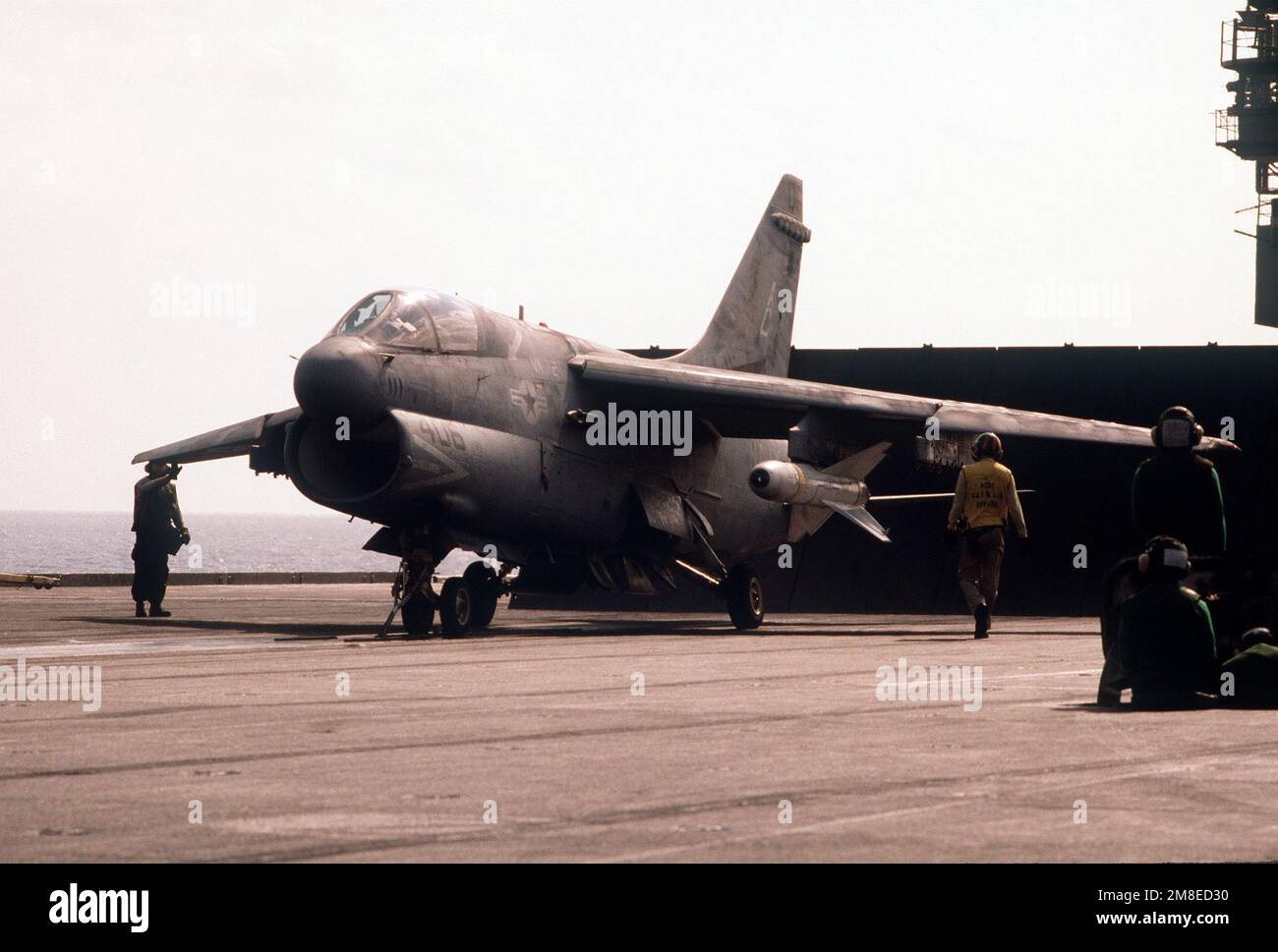 With the jet blast deflector raised behind it, an A-7E Corsair aircraft ...