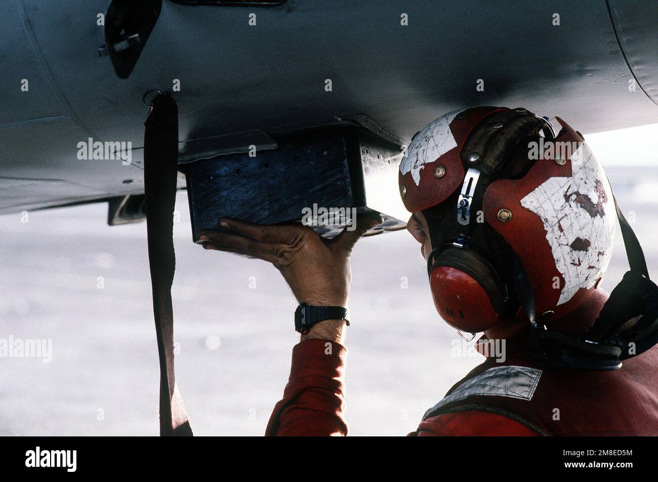 An aviation ordnanceman on the flight deck of the aircraft carrier USS ...