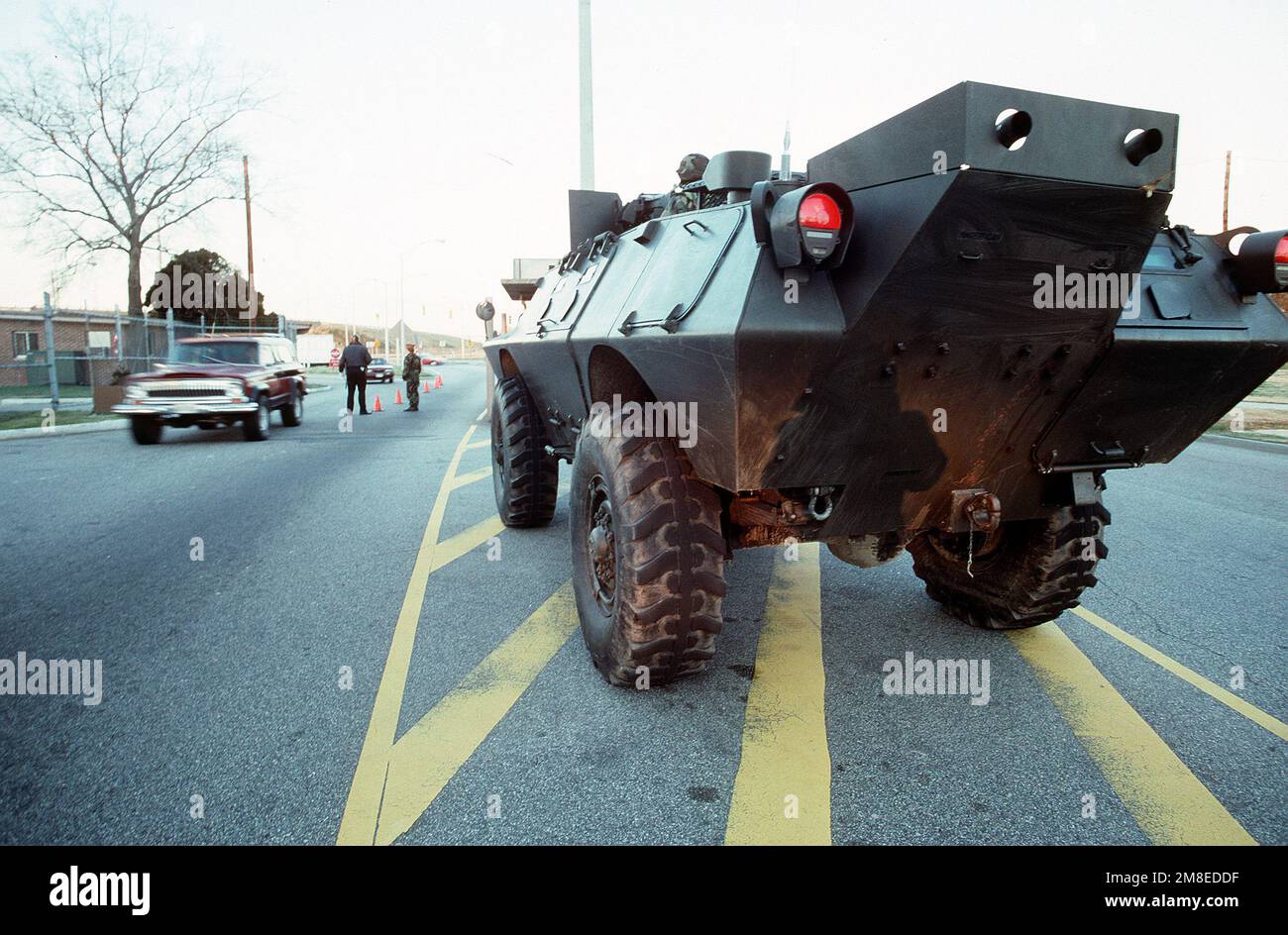 A V-100 Commando armored vehicle patrols the roadway in an effort to ...