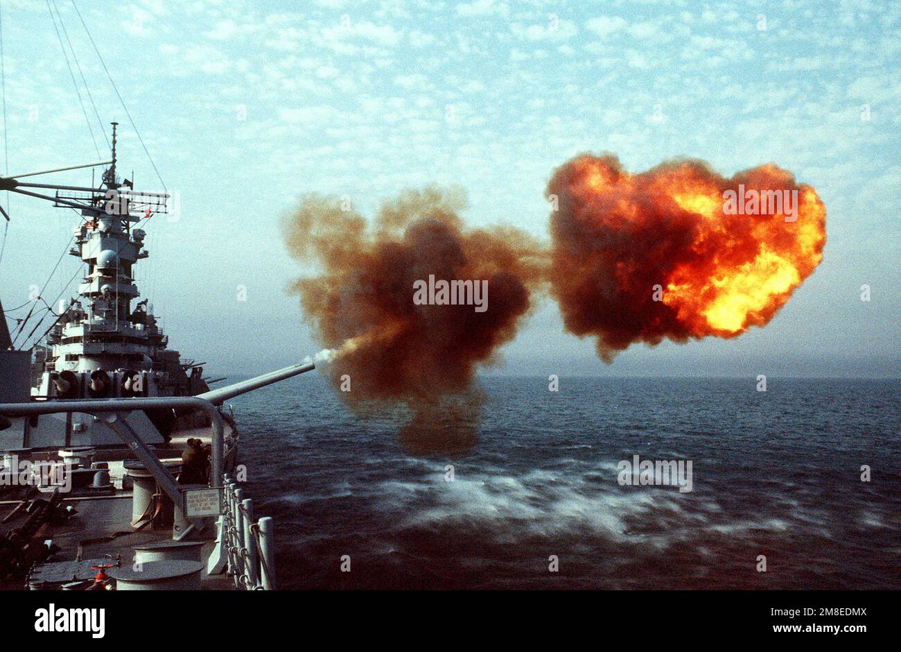 The battleship USS WISCONSIN (BB-64) fires a round from one of the Mark ...