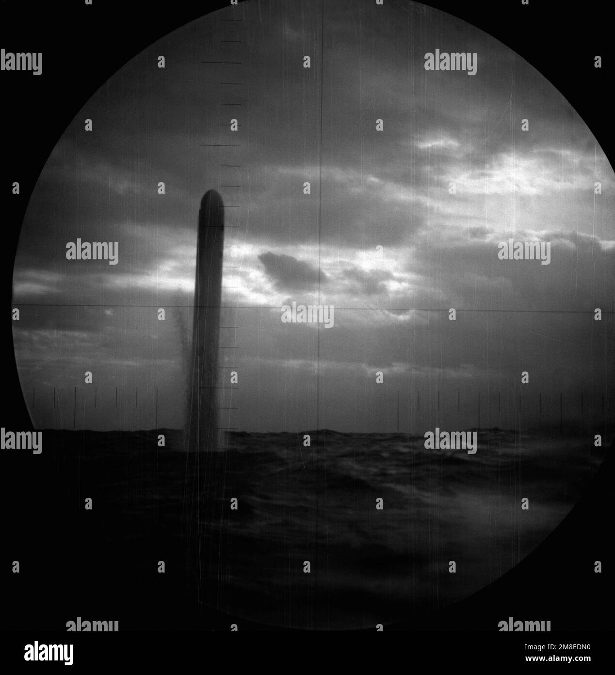 As seen through the submarine's periscope, a BGM-109 Tomahawk land ...