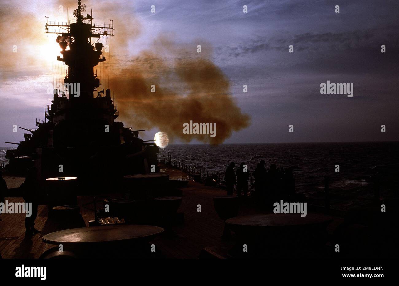 The battleship USS WISCONSIN (BB-64) fires one of its Mark 28 5-inch/38 ...