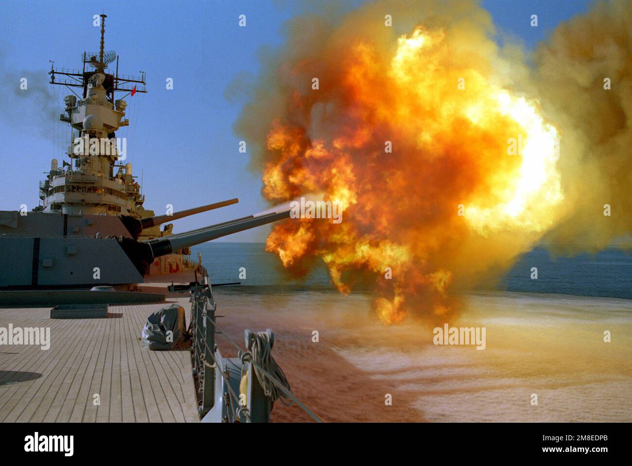 The battleship USS WISCONSIN (BB-64) fires a round from one of the Mark ...