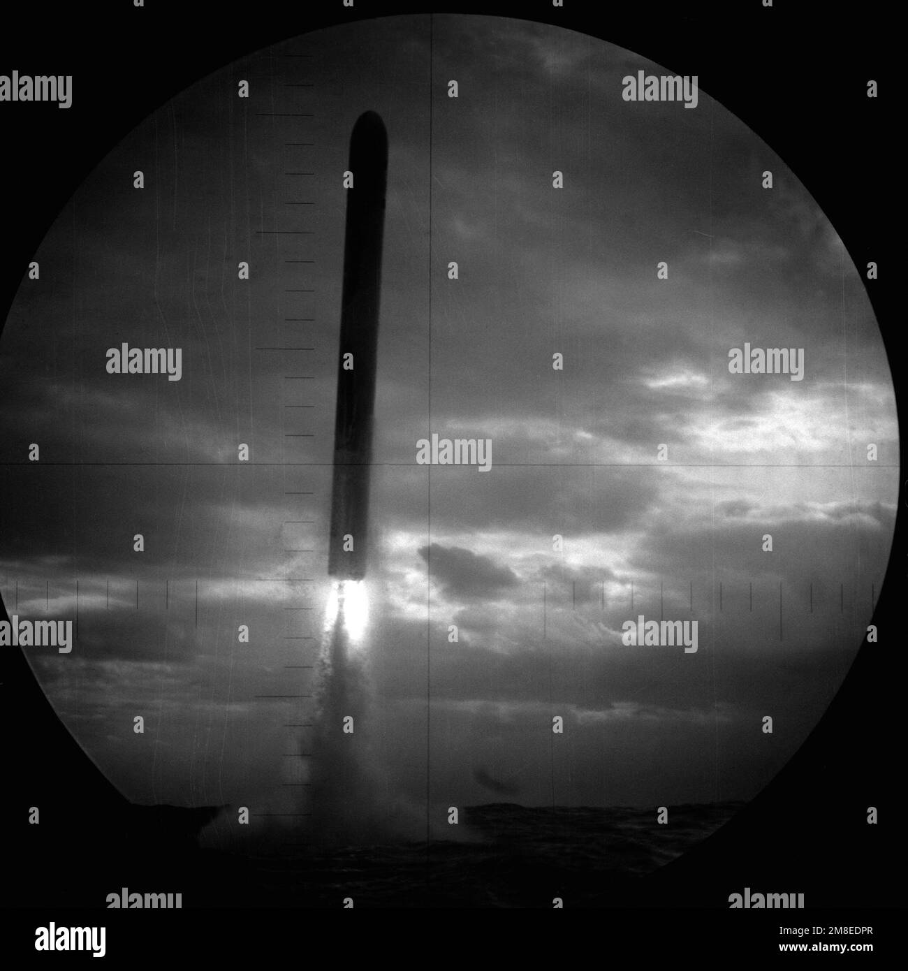 As seen through the submarine's periscope, a BGM-109 Tomahawk land ...