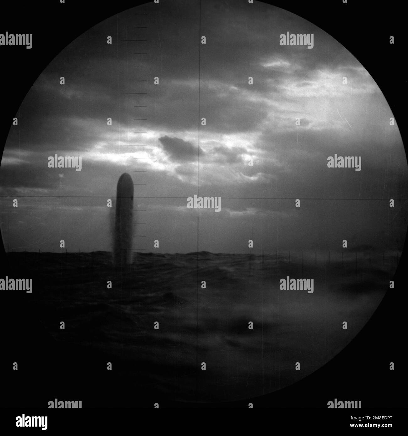 As seen through the submarine's periscope, a BGM-109 Tomahawk land ...