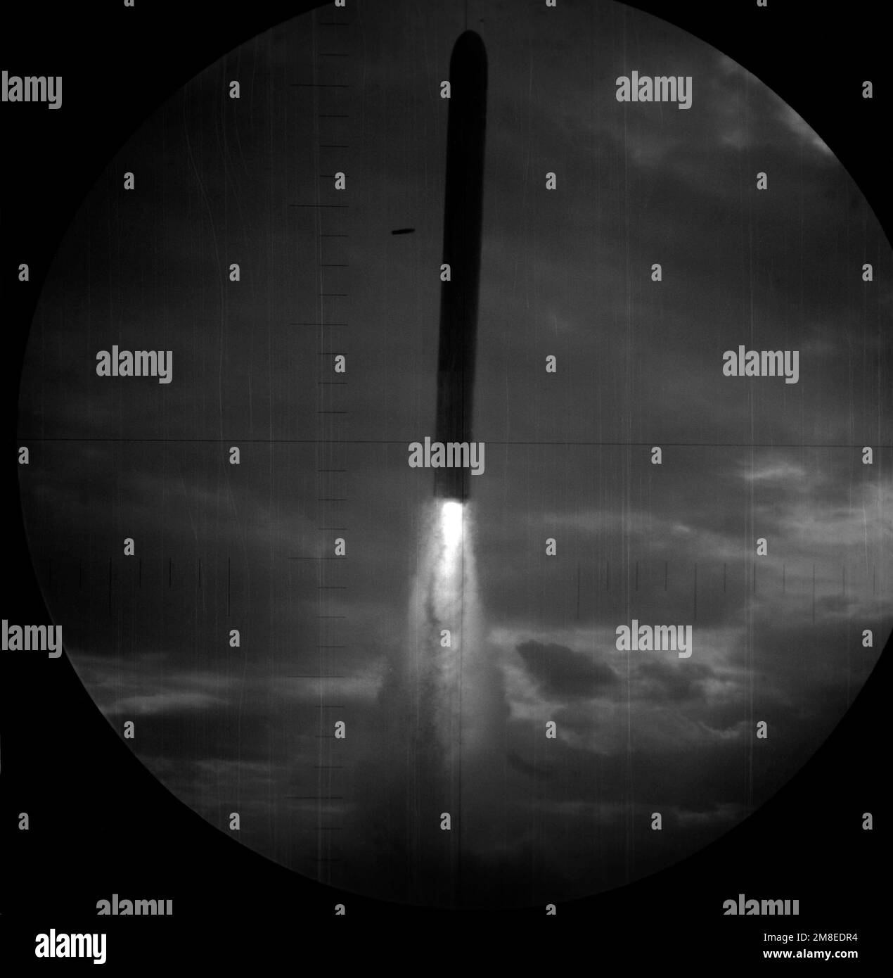 As seen through the submarine's periscope, a BGM-109 Tomahawk land ...