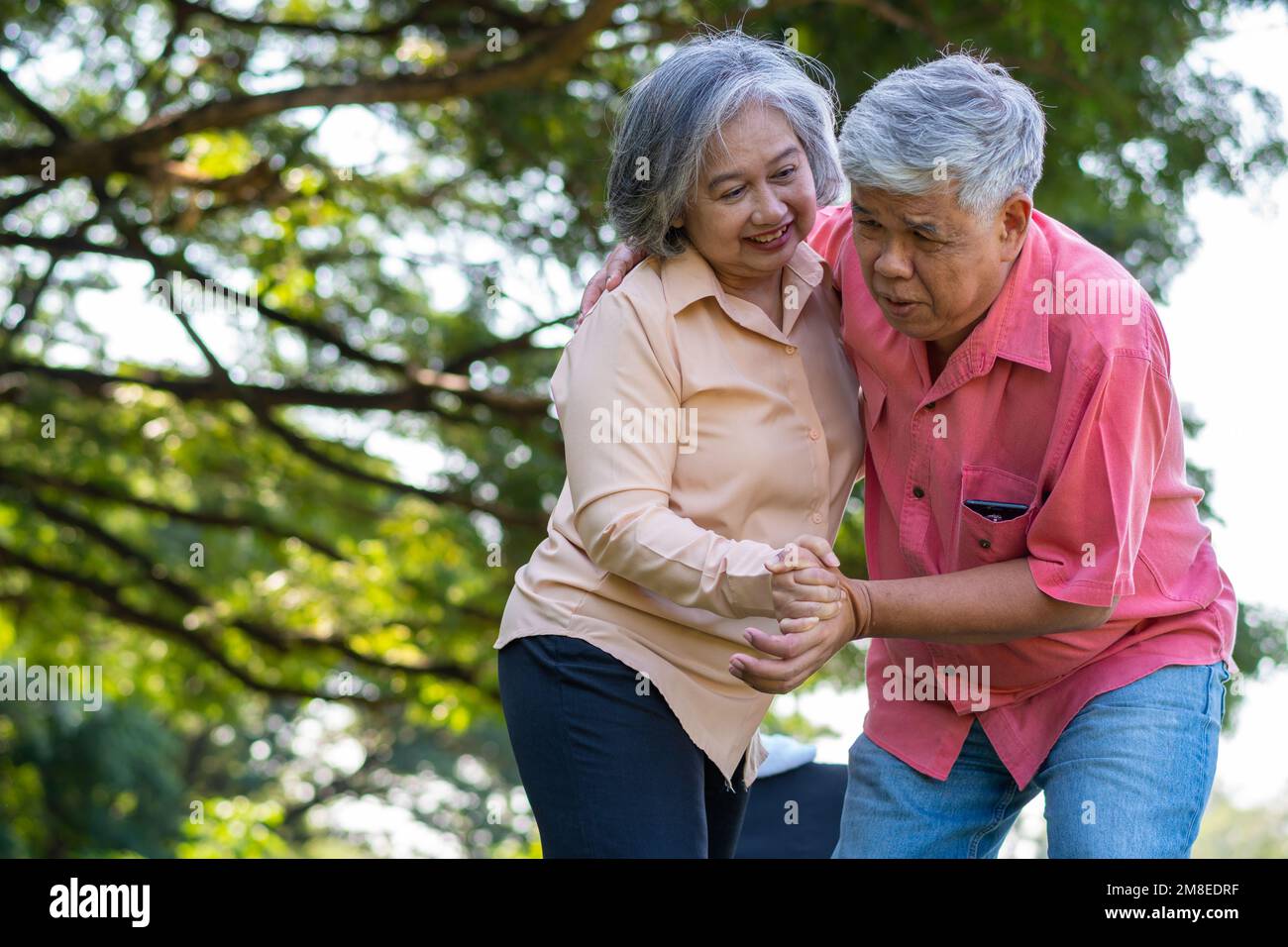 Asian senior man falling down on lying floor at park after Stumbled and ...