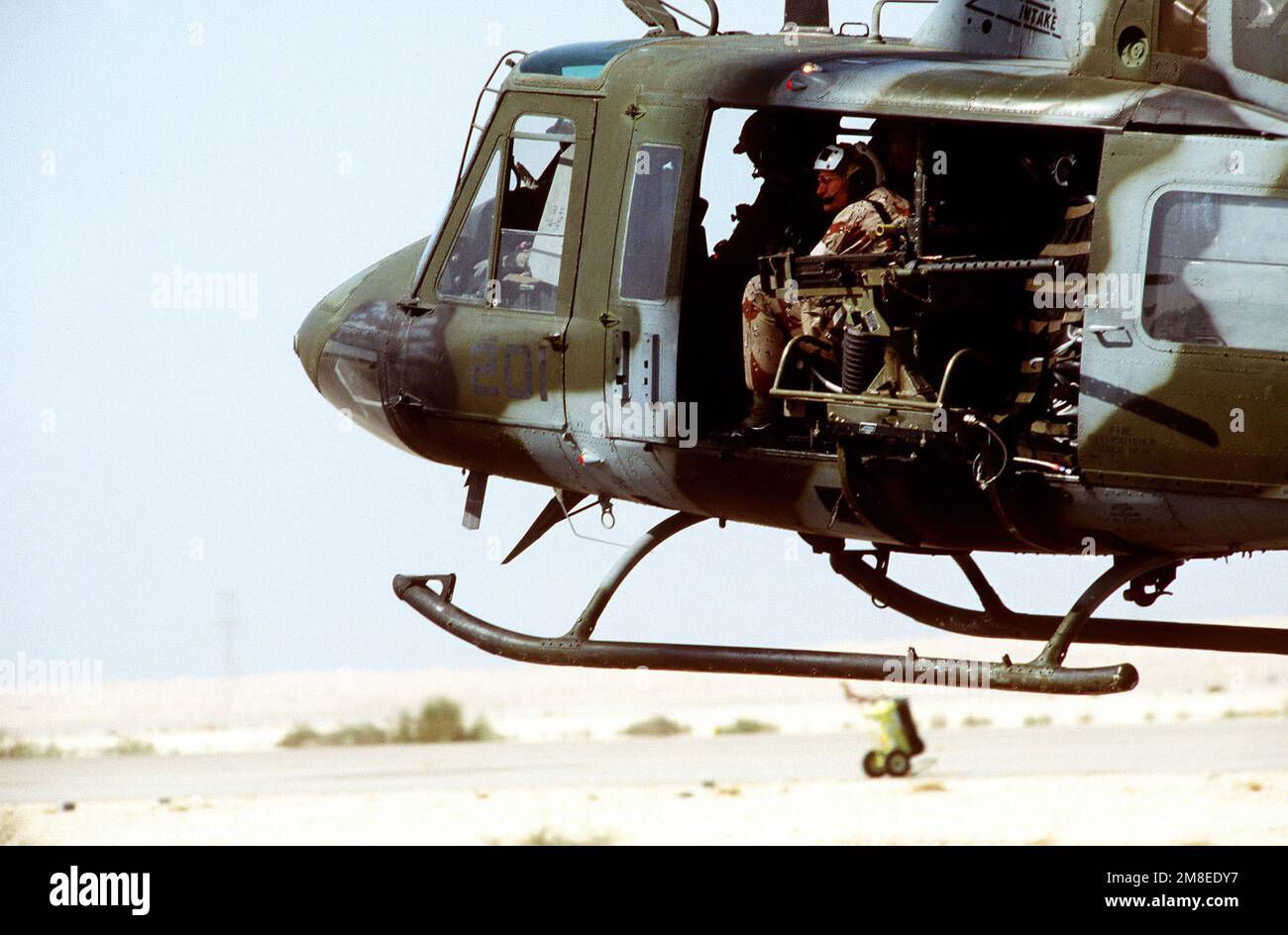 A UH-1N Iroquois helicopter, armed with a door-mounted .50-caliber ...