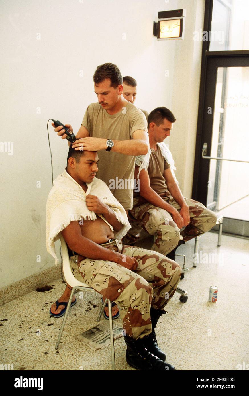 U.S. military personnel take a break to get haircuts during Operation ...