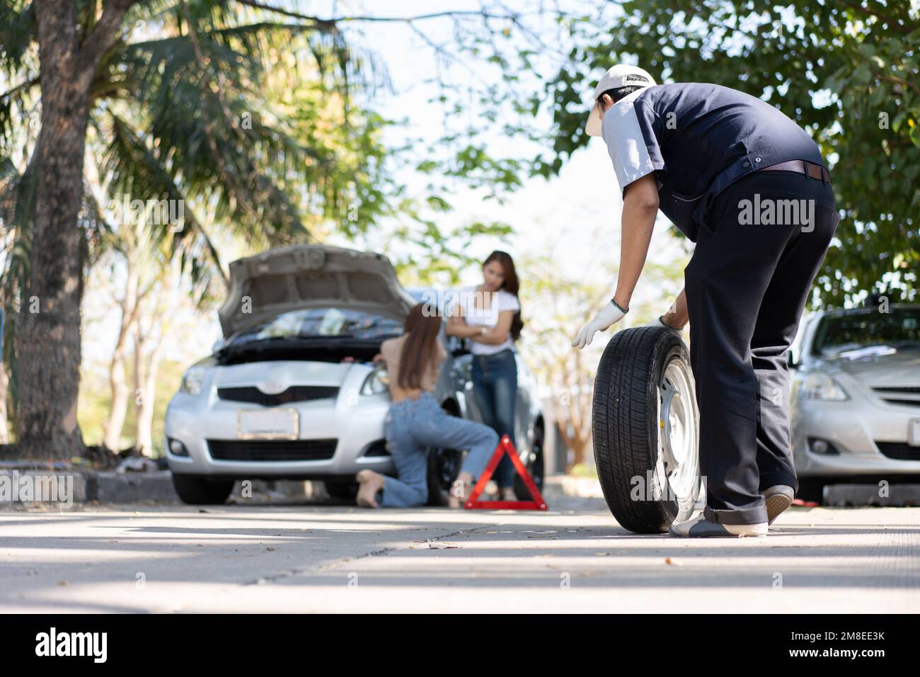 Expertise mechanic man in uniform using force trying to unscrew the ...