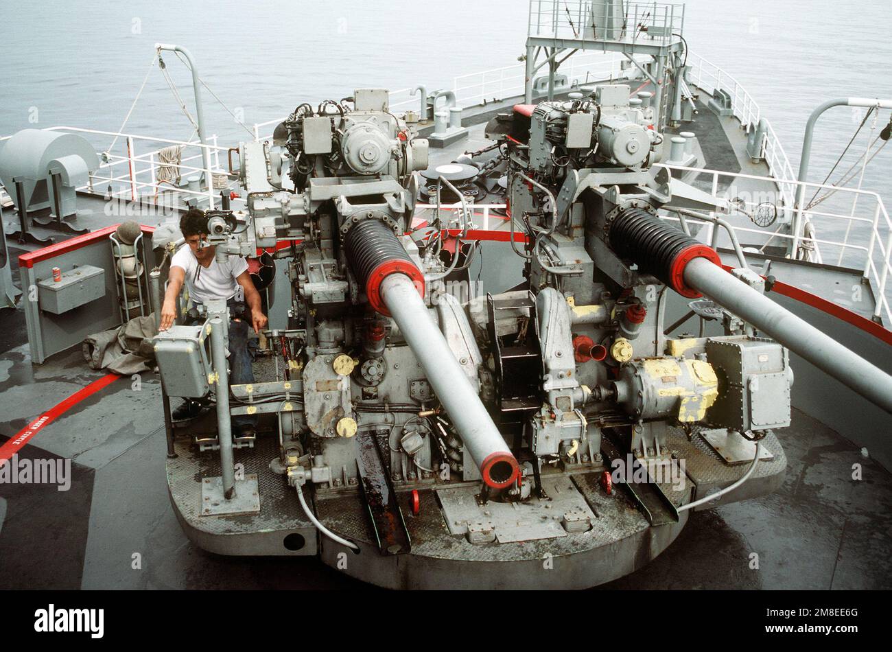 GUNNER's Mate D. Schuchard inspects the Mark 33 3-inch/50-caliber guns ...