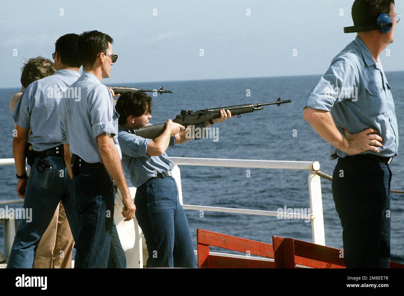 Instructor PH1 Phil Goodrich stands by as Yeoman 3rd Class Aida Cabrera ...