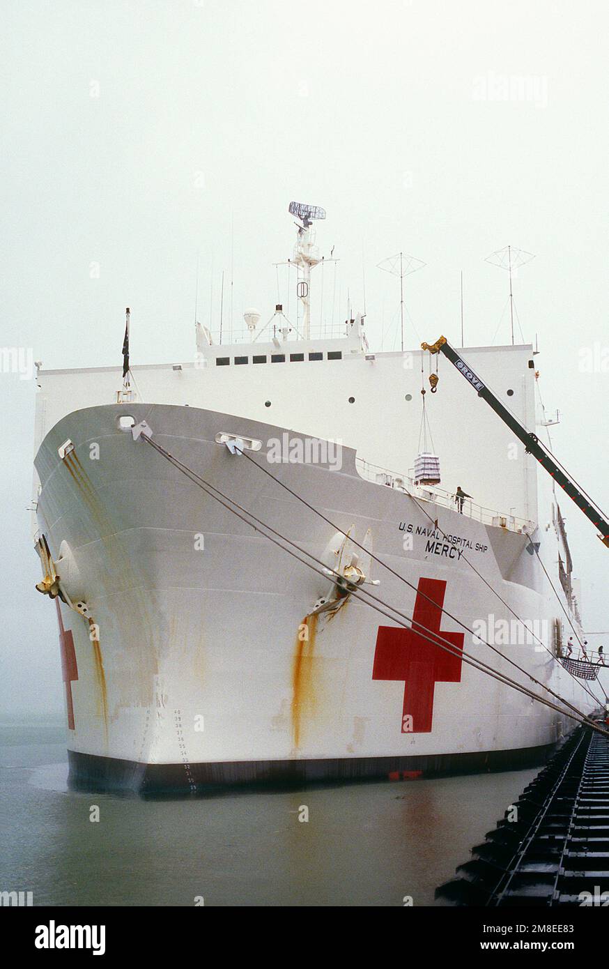 The hospital ship USNS MERCY (T-AH-19) is moored to a pier prior to ...