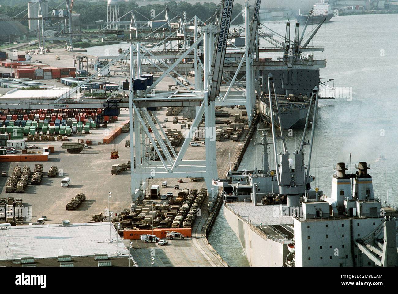 Equipment of the 24th Infantry Division lines the pier prior to loading ...