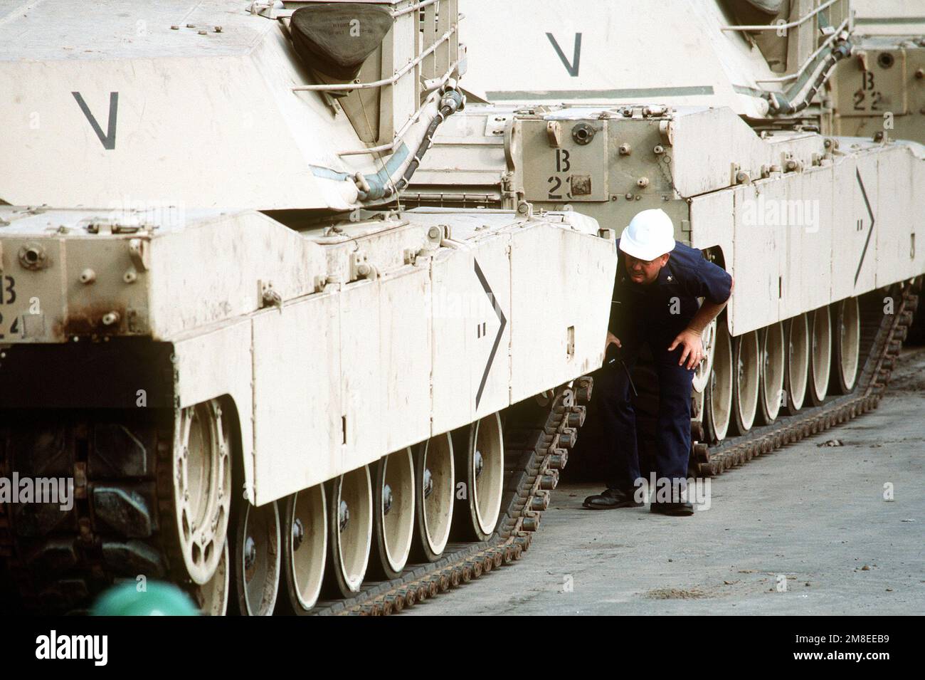 A workman inspect M-1A1 Abrams main battle tanks and M-2 Bradley ...