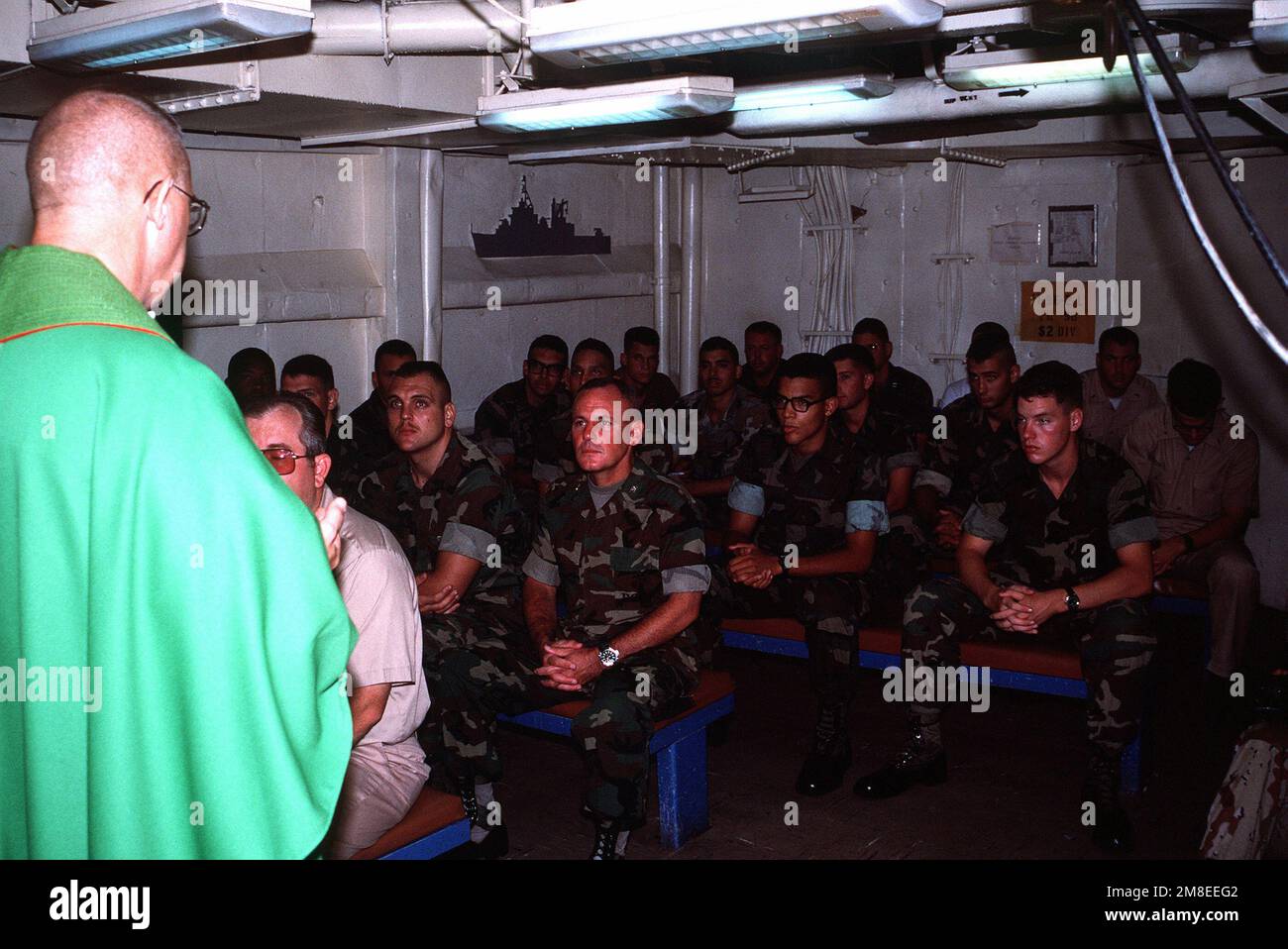 Crew members and embarked Marines aboard the amphibious transport dock ...