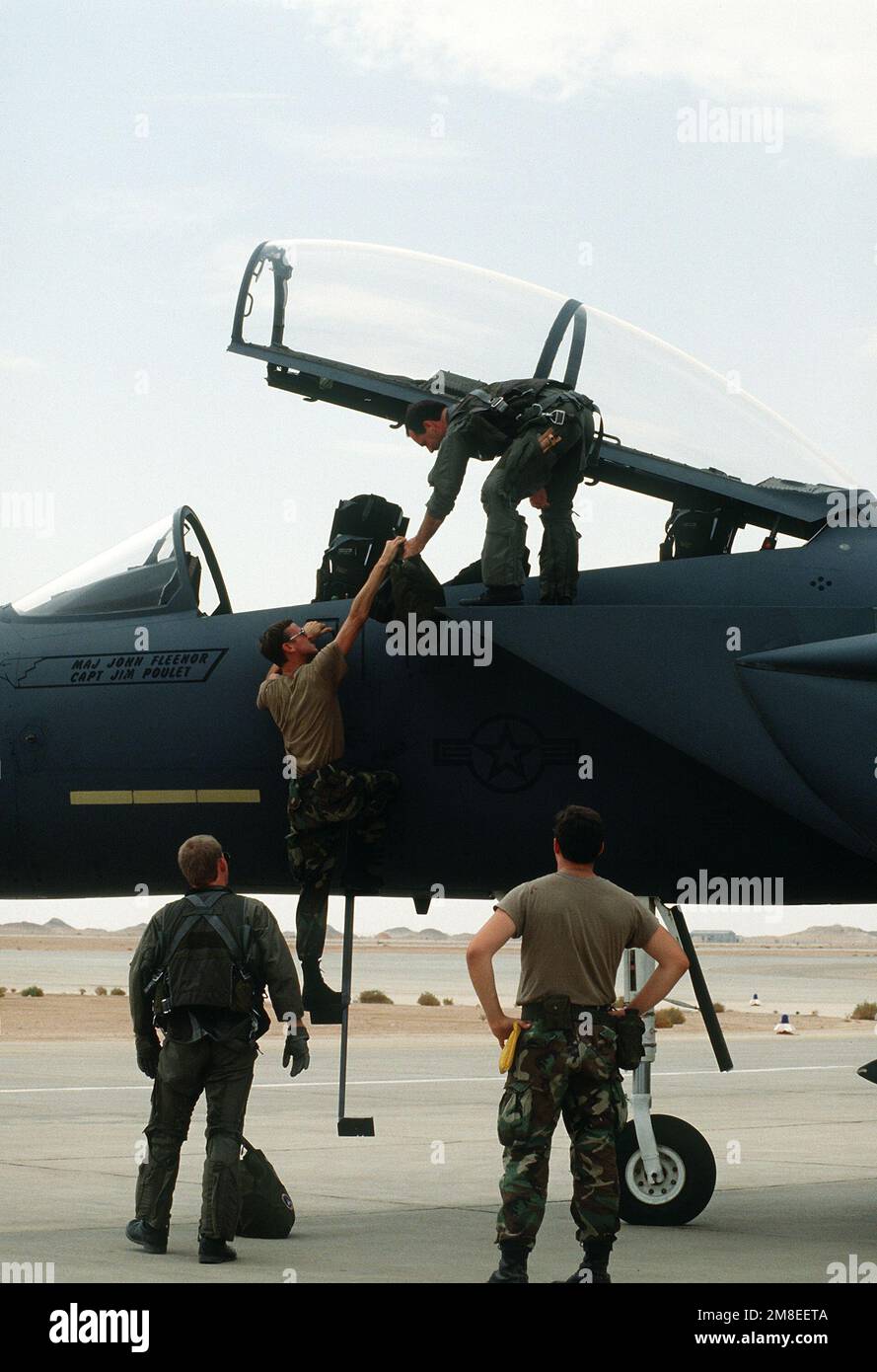 The weapon systems officer of an F-15E Eagle aircraft is handed his ...