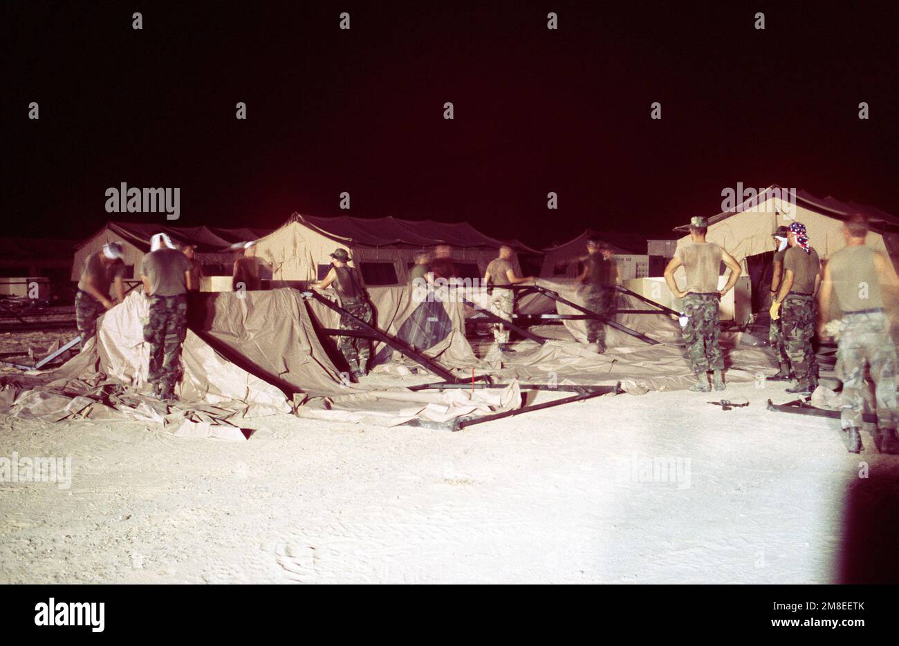 Members of the 2849th Civil Engineering Squadron construct a tent city ...