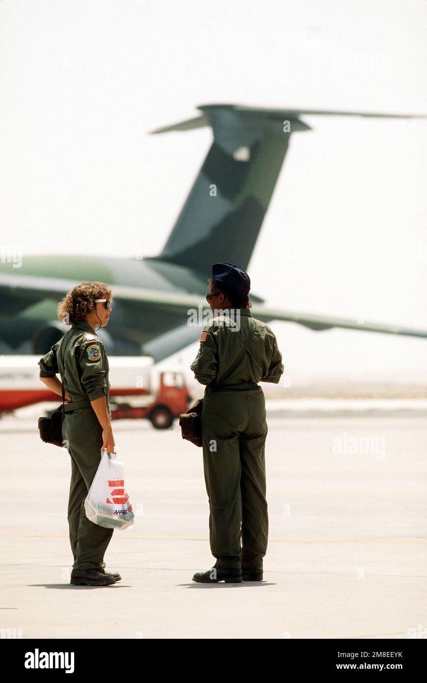 Two members of the 2nd Aeromedical Evacuation Squadron talk on the ...